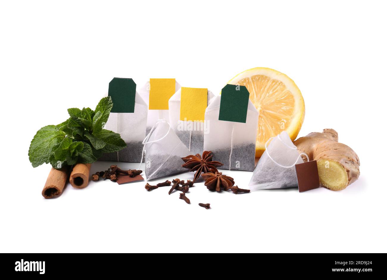 Different tea bags, spices and half of lemon on white background Stock ...