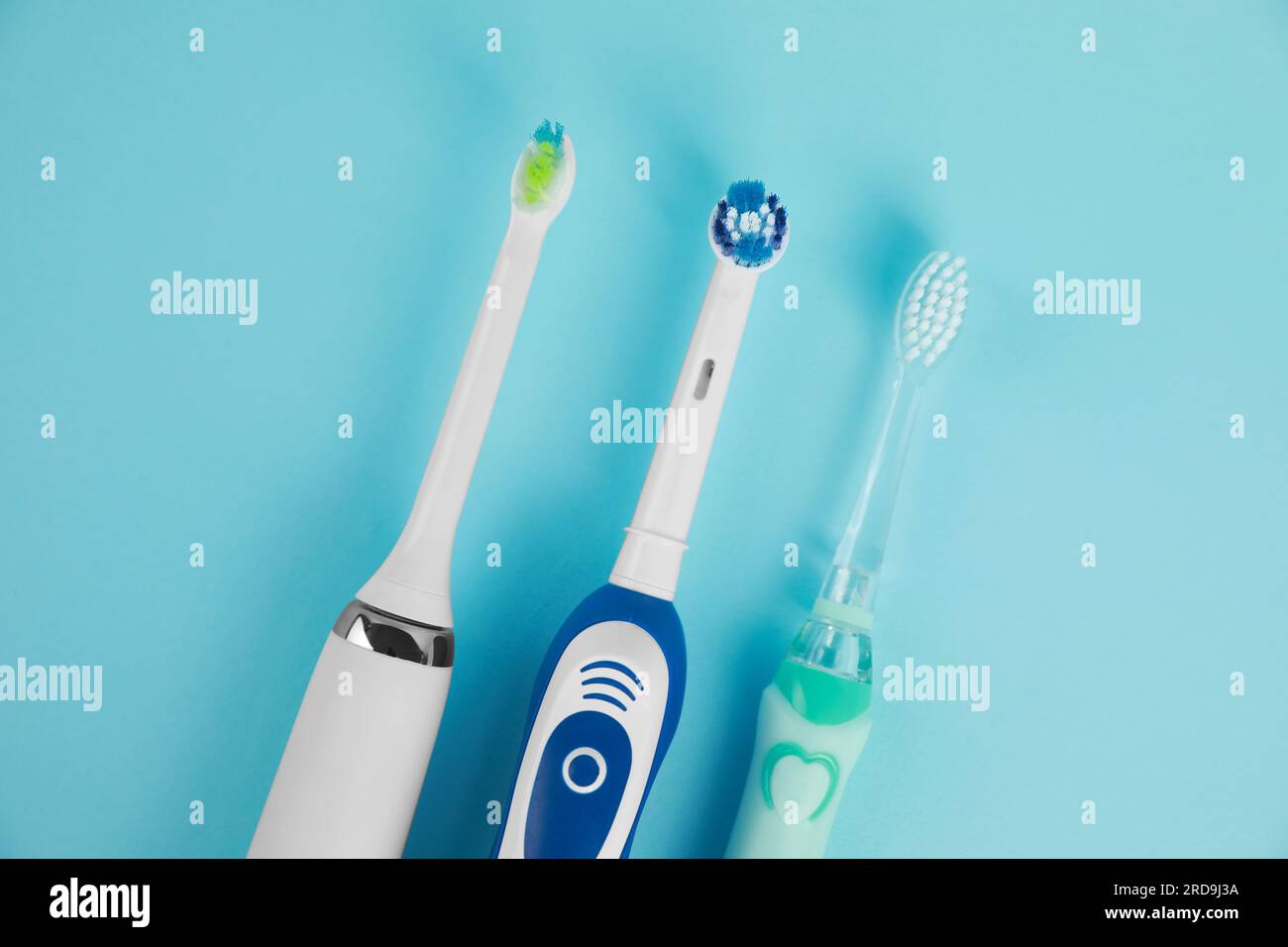 Electric toothbrushes on light blue background, flat lay Stock Photo ...