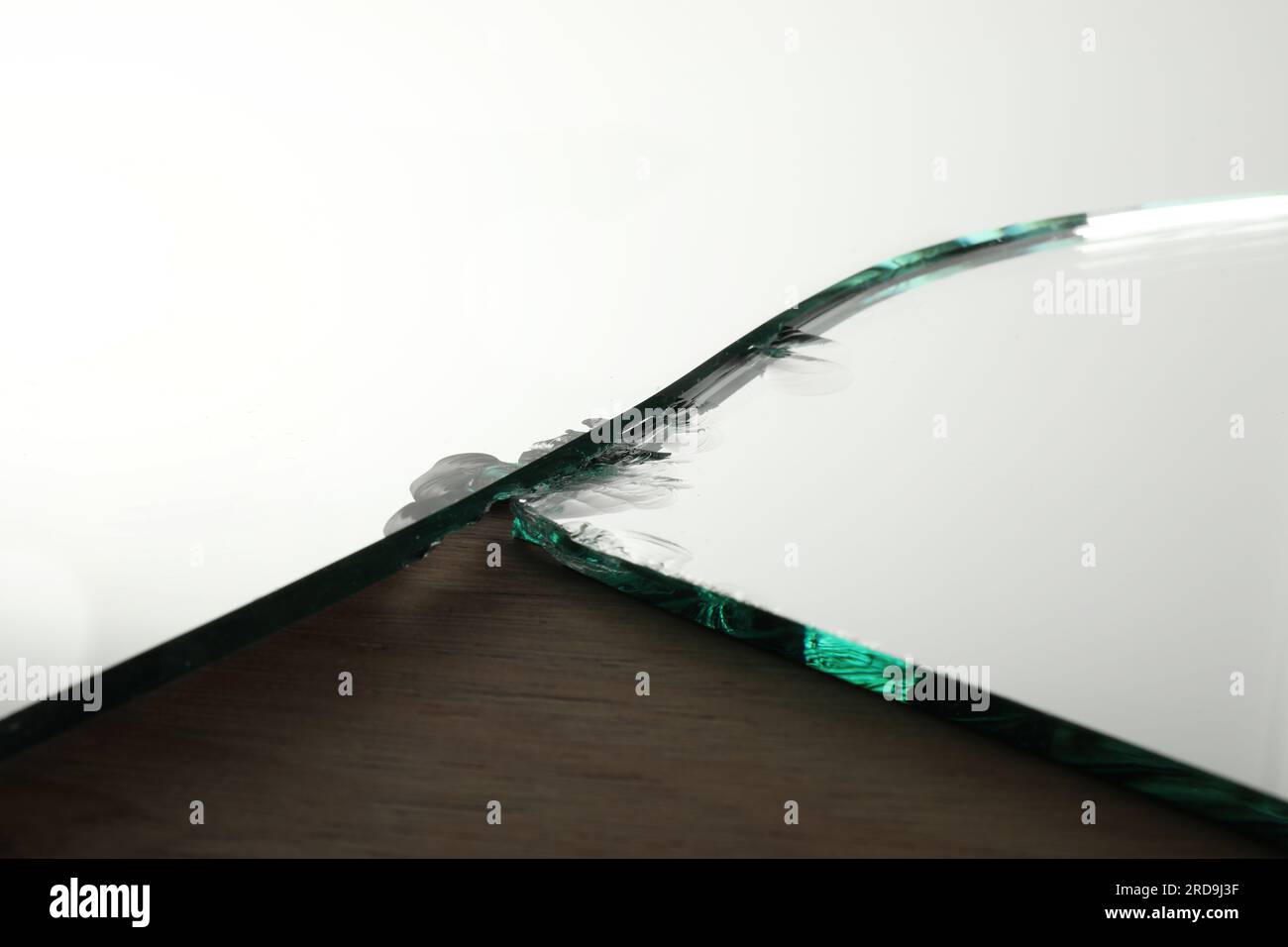 Shard of broken mirror on wooden backing board, closeup Stock Photo - Alamy