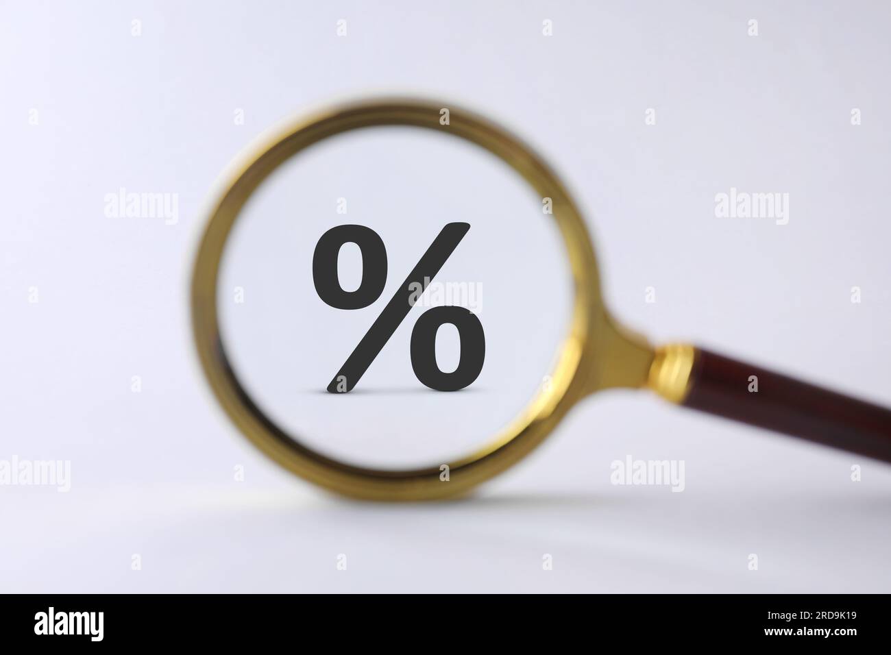 Percent sign on white background, view through magnifying glass Stock ...