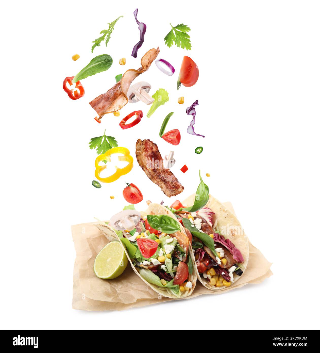 Delicious tacos. Ingredients falling into tortillas on white background ...