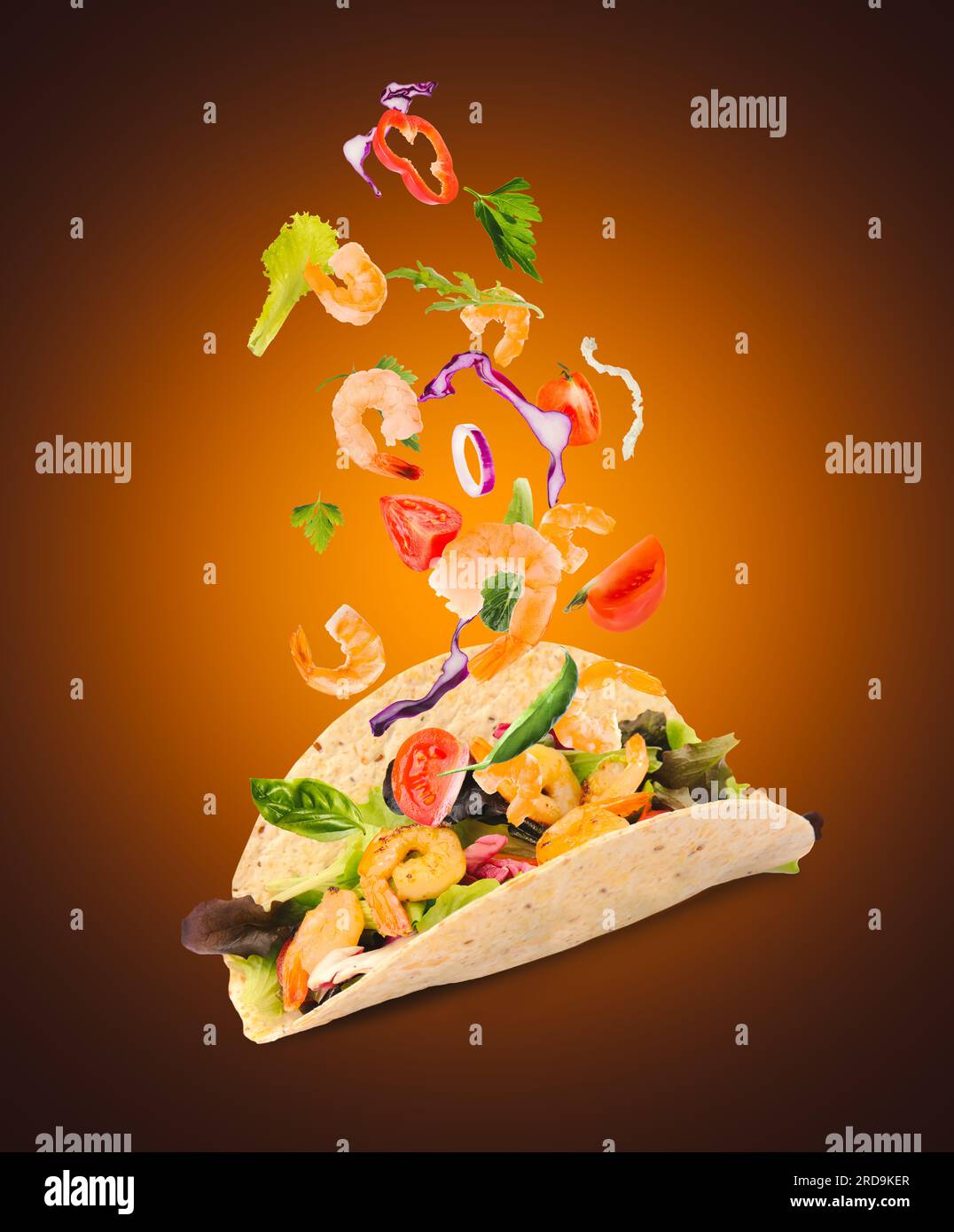 Delicious tacos. Ingredients falling into tortilla on dark orange ...