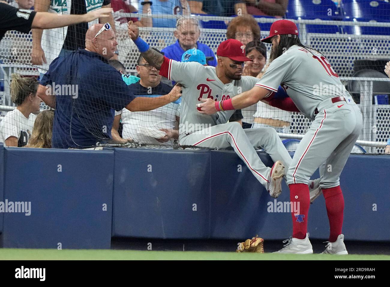 Philadelphia Phillies center fielder Brandon Marsh, right, helps ...