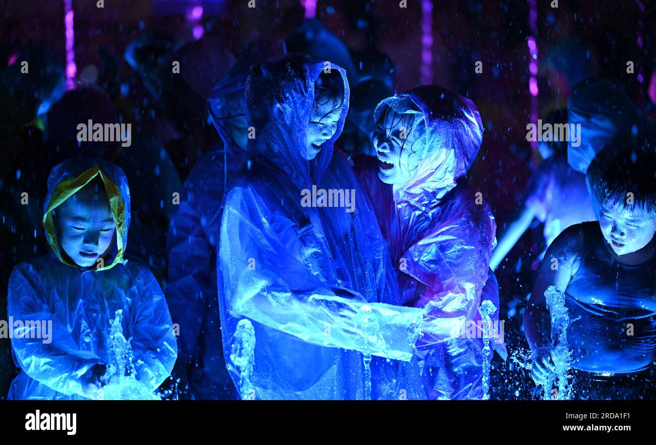 KORLA, CHINA - JULY 19, 2023 - Children cool off in the music fountain ...