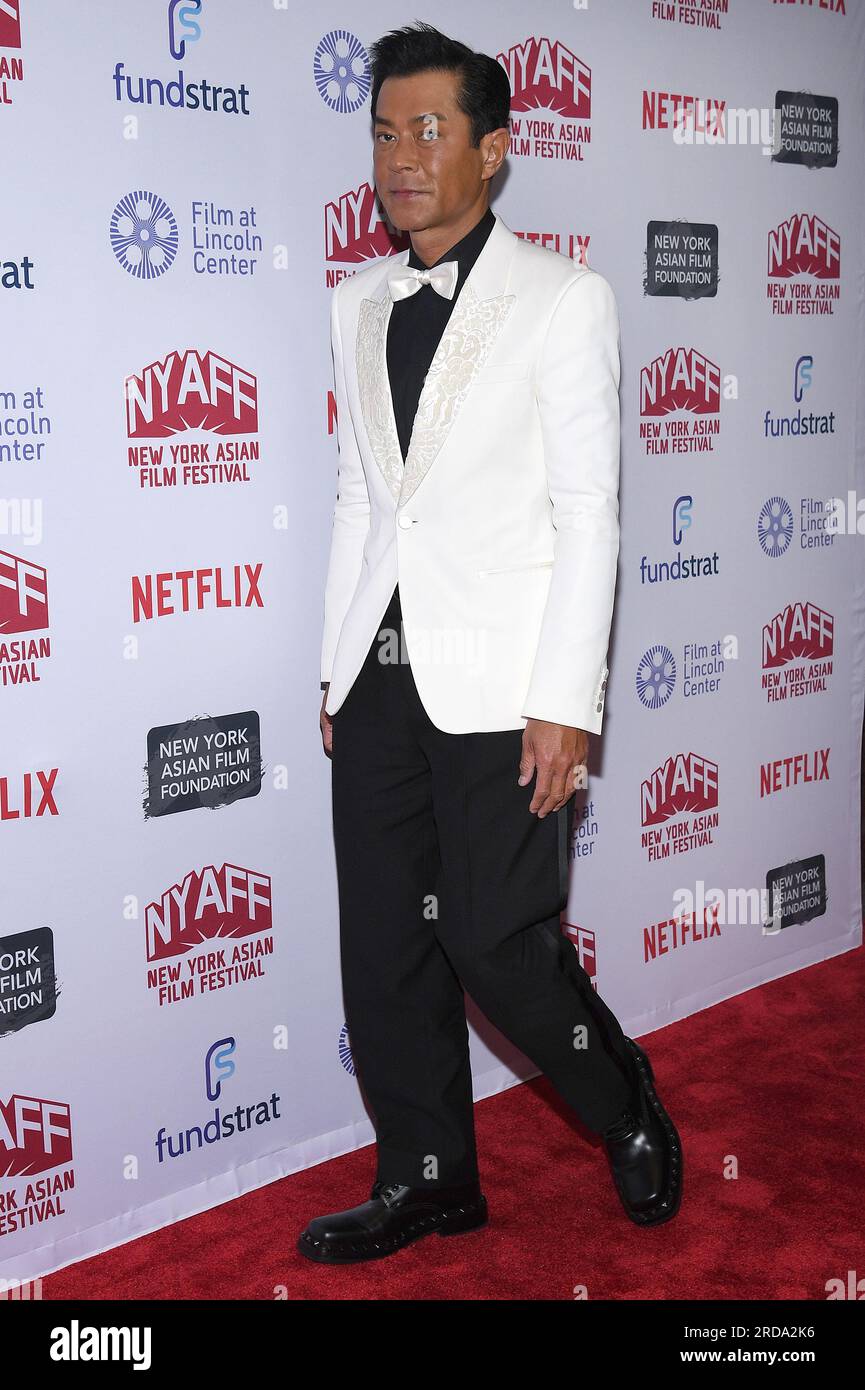 New York, USA. 19th July, 2023. Actor Louis Koo walks the red carpet at ...