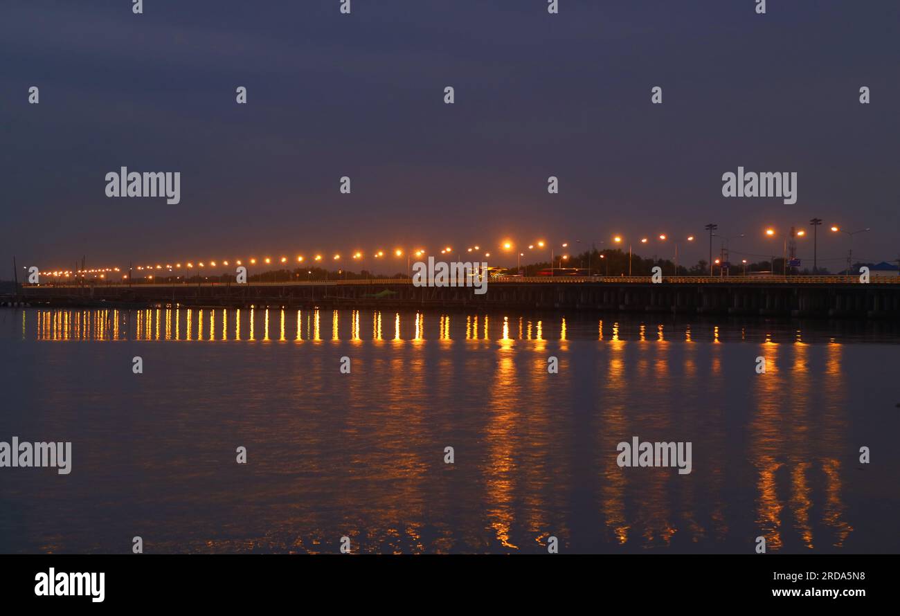 Bridge with Lighting Reflections on the Sea at Night Stock Photo - Alamy