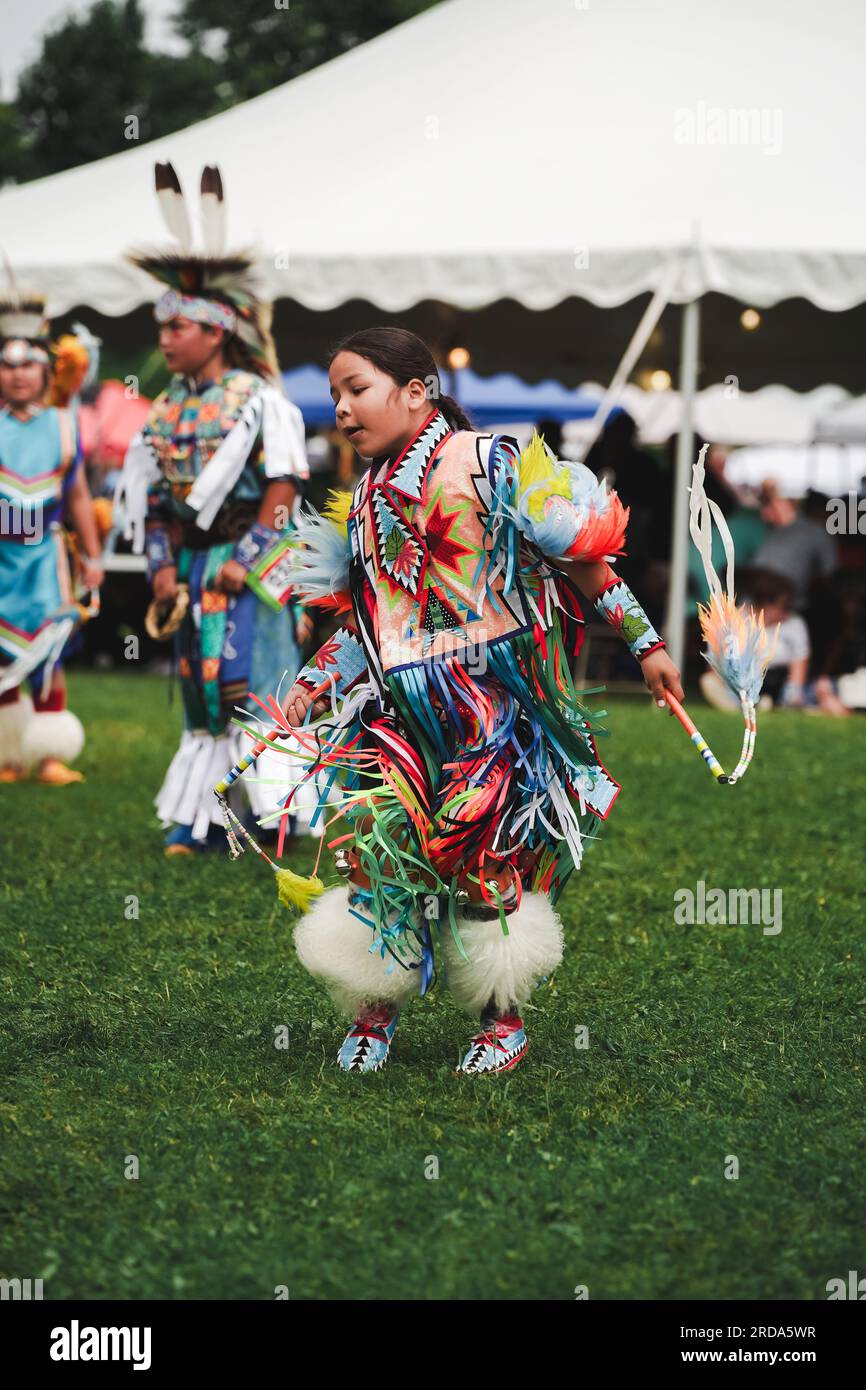 young native American boy dressed in colorful dancing outfit at pow wow ...