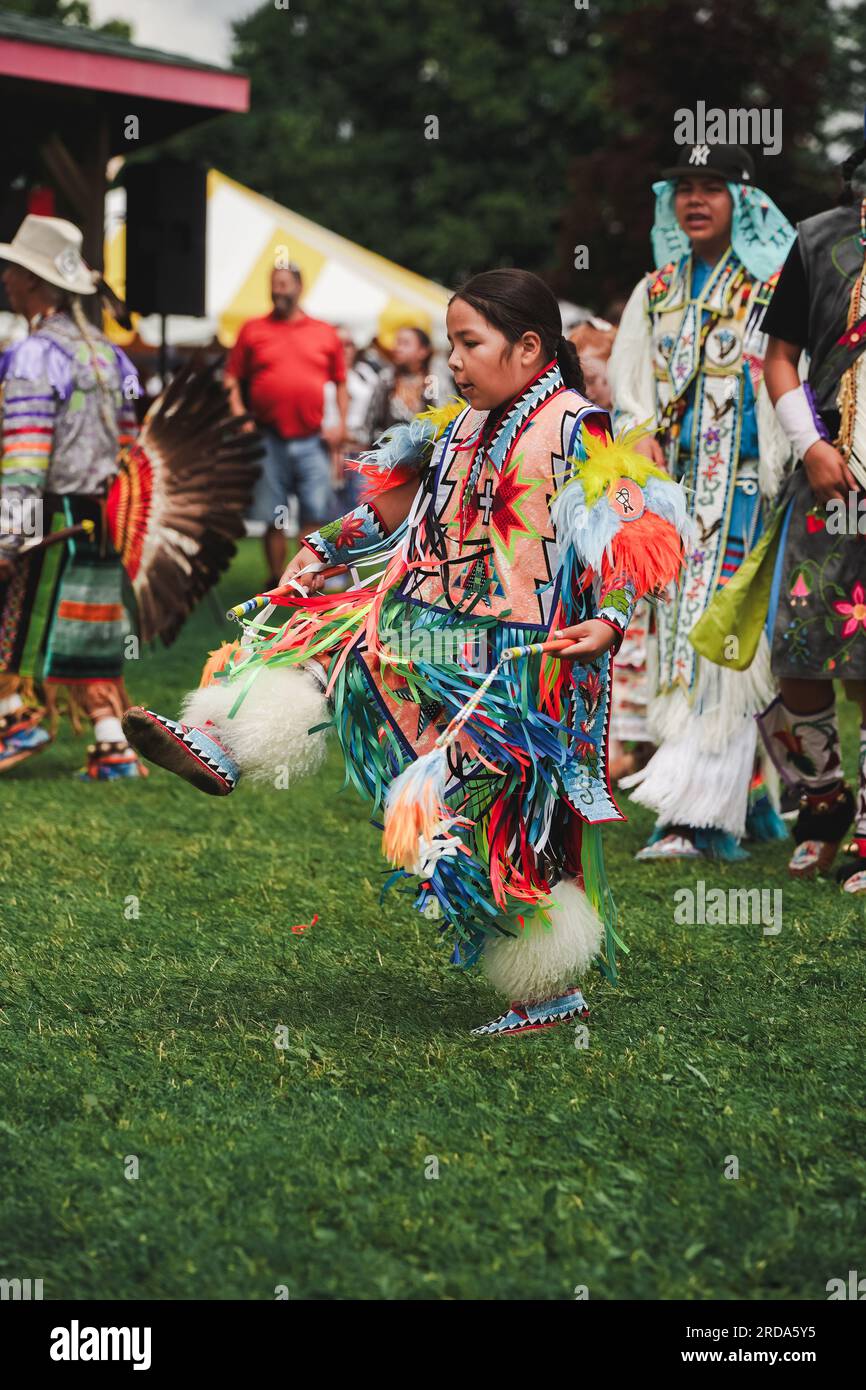 young native American boy dressed in colorful dancing outfit at pow wow ...