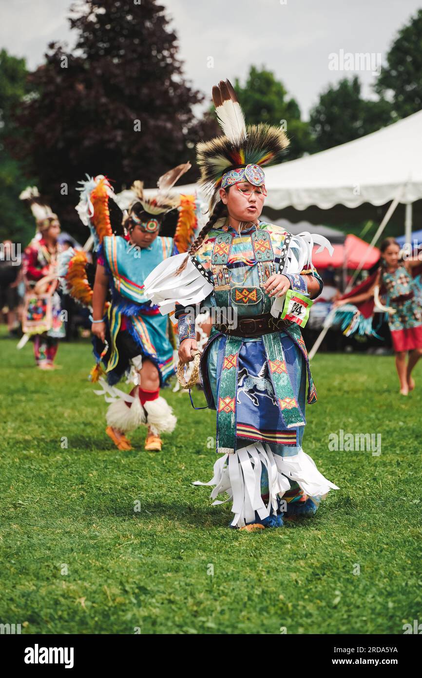 young native American boy dressed in colorful dancing outfit at pow wow ...