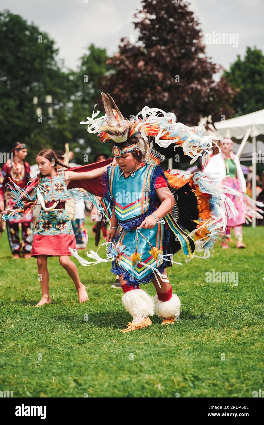 young native American boy dressed in colorful dancing outfit at pow wow ...