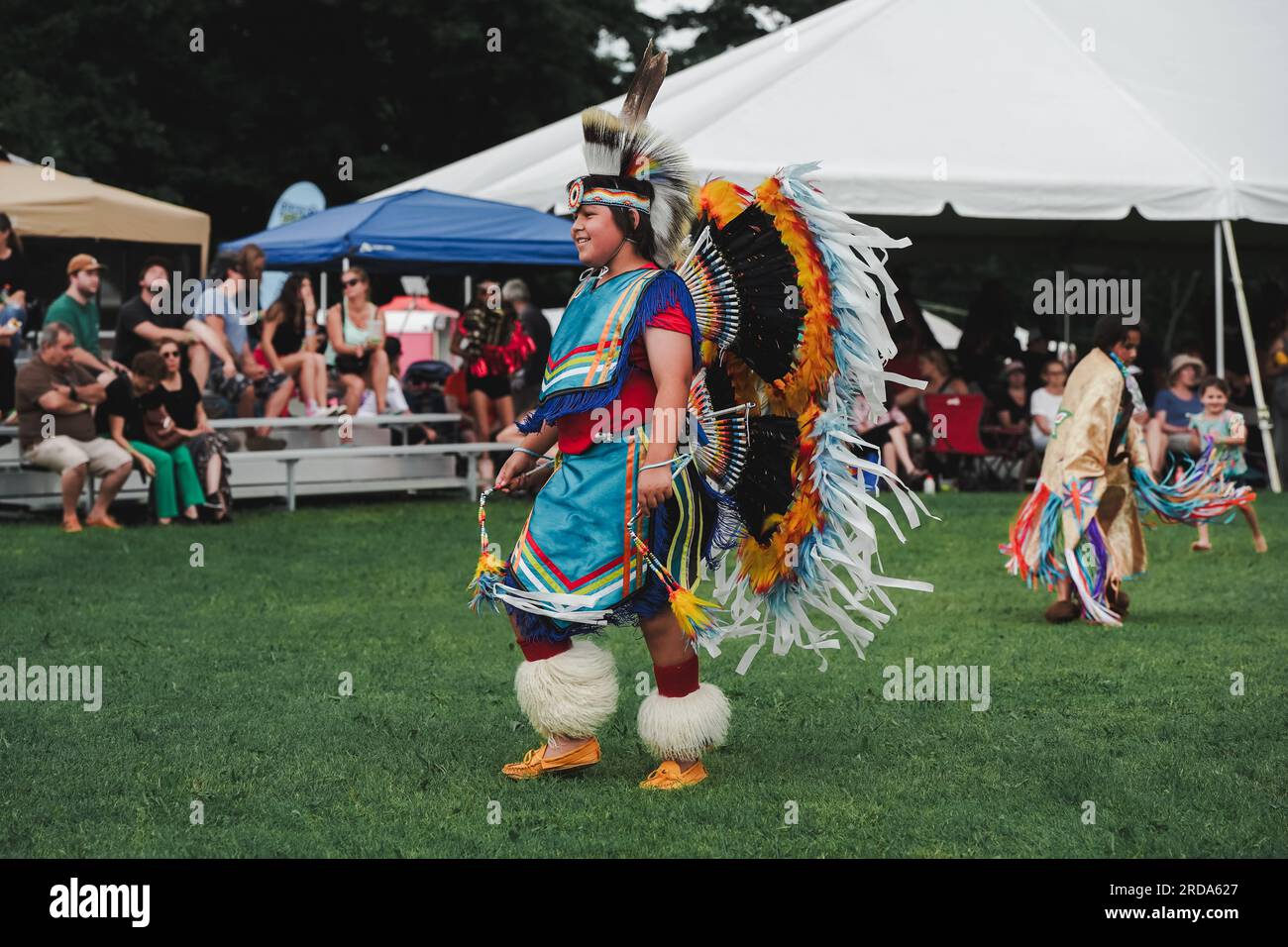 young native American boy dressed in colorful dancing outfit at pow wow ...