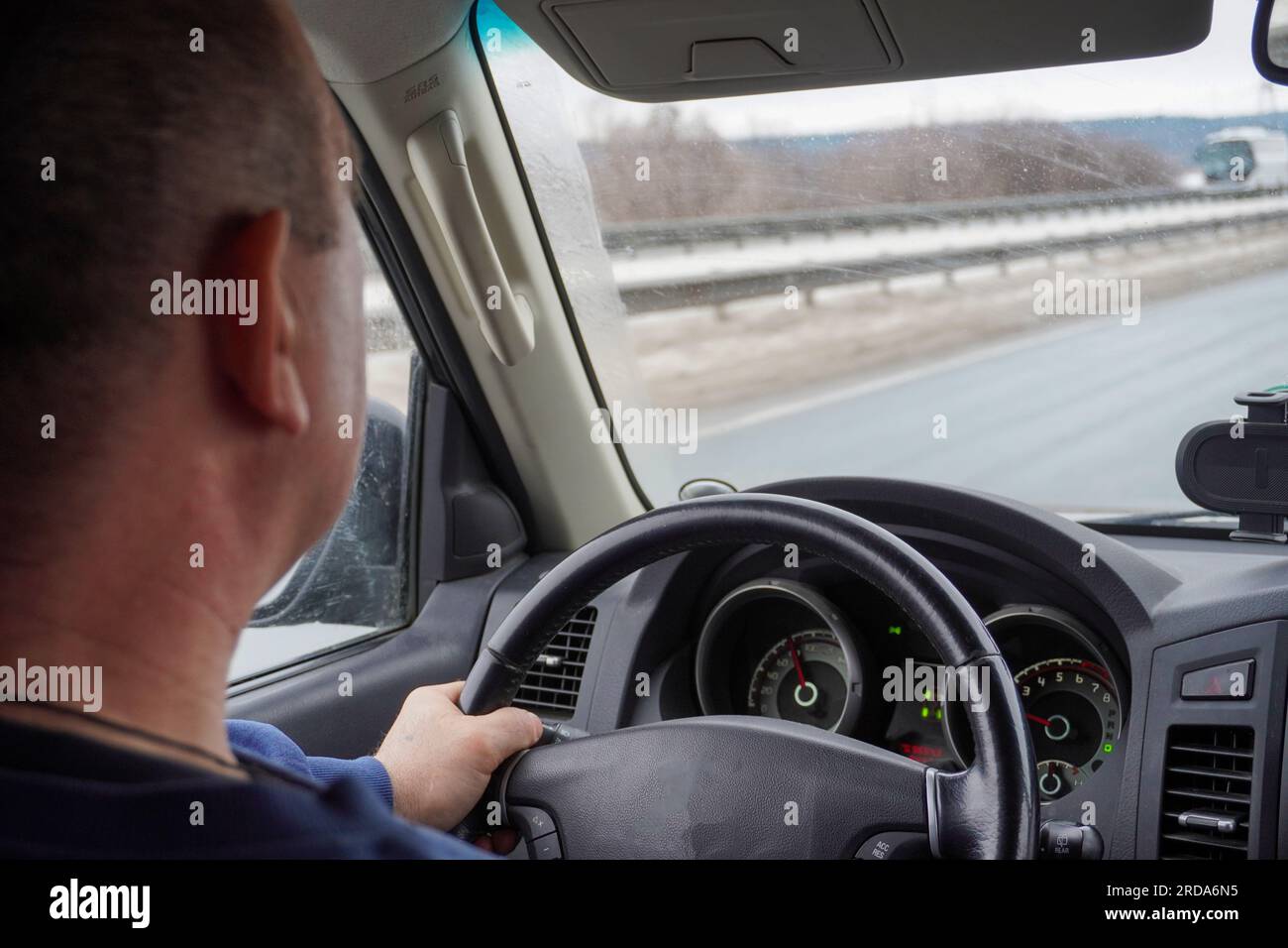 a man is driving a car, rear view, you can see the track in the window ...