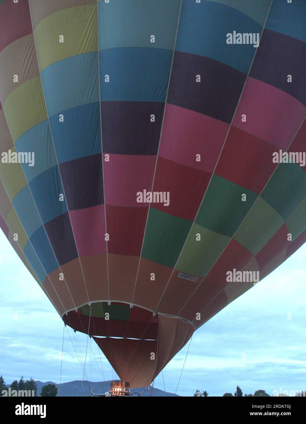 Inflation process and preparation of hot air balloon at sunrise to fly ...