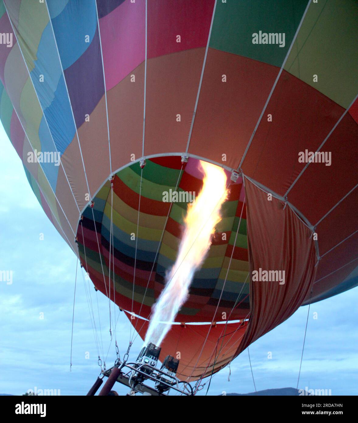 Inflation process and preparation of hot air balloon at sunrise to fly ...