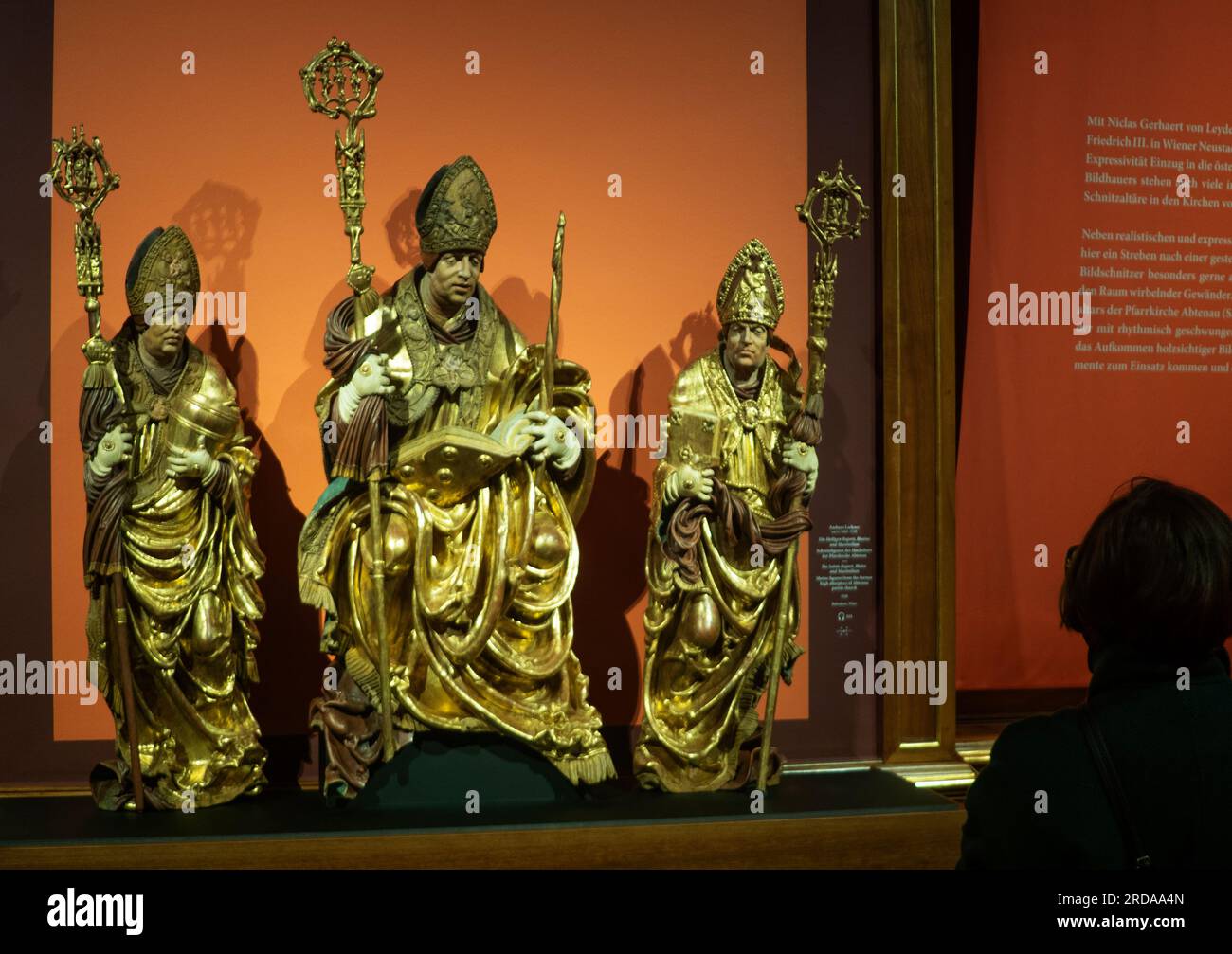 A visitor to the exhibition examines the Enthroned St. Blasius with the ...
