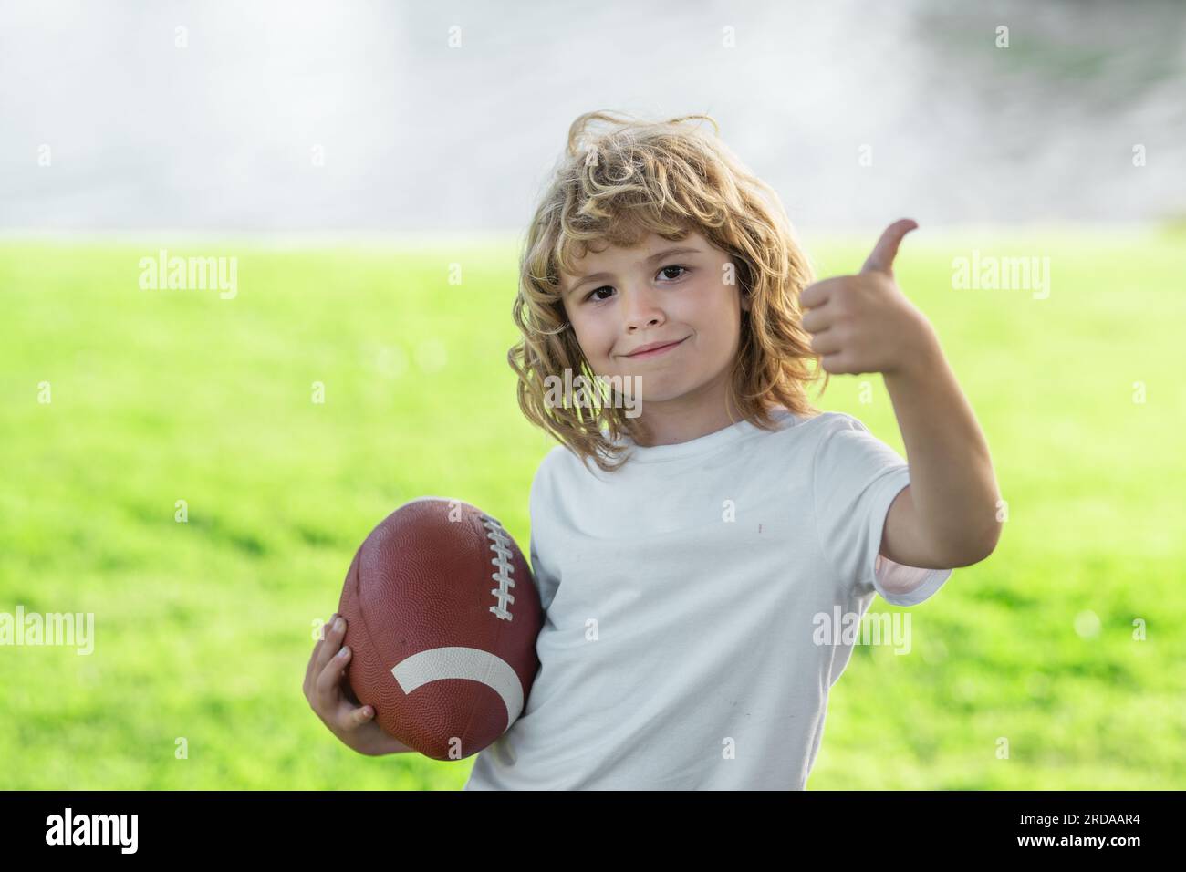 American football. Child ready to throw a football. Sport kids concept ...