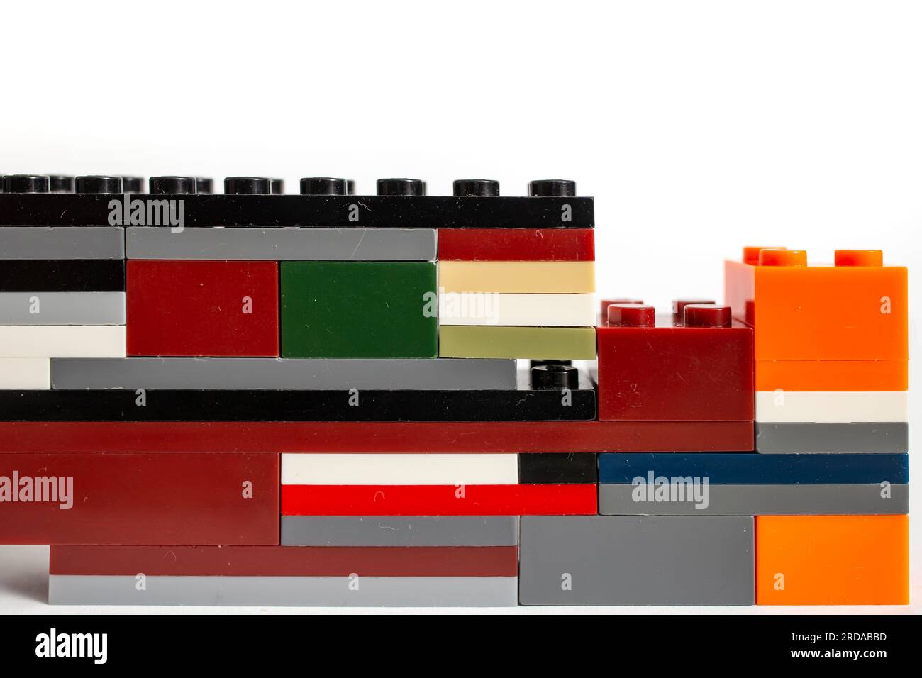 Colorful plastic bricks stacked on white background, playful toys ...