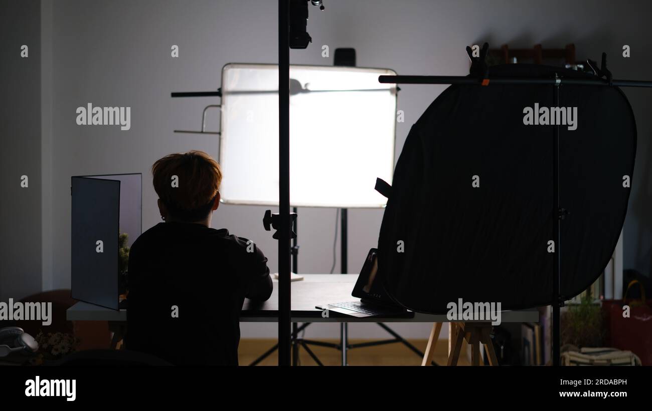 Silhouette of man in studio setting camera and lighting for taking ...
