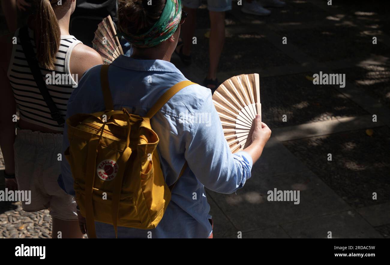 Palma, Spain. 19th July, 2023. July 19, 2023, Palma: People with a fan ...