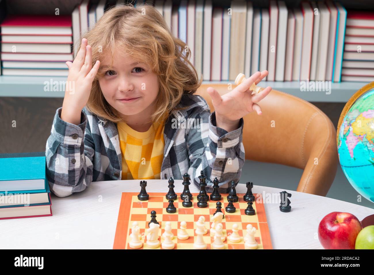 Little chess player. Kid playing chess. Child thinking near chessboard ...