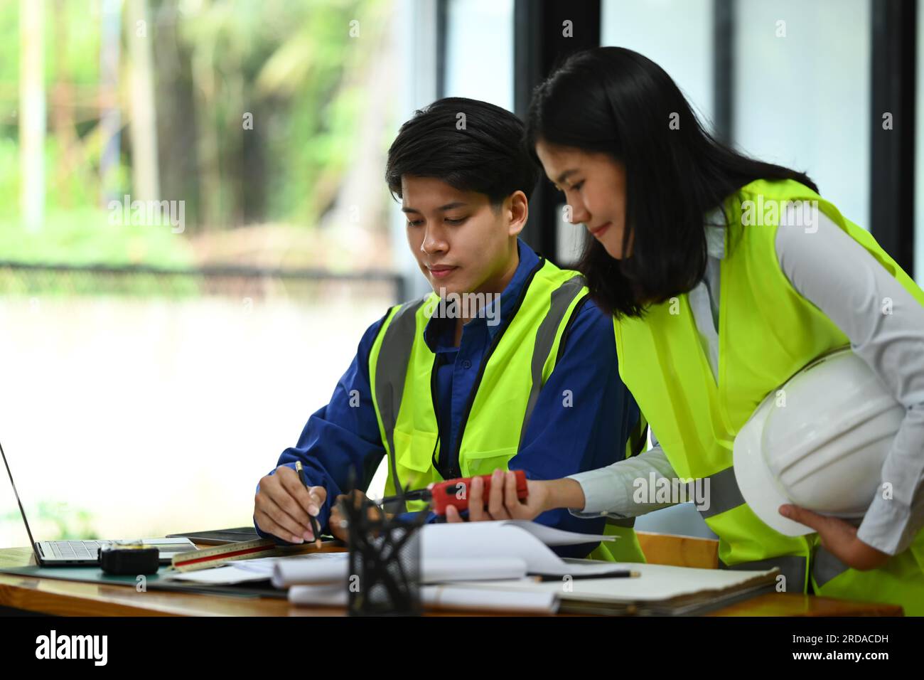 Team of civil engineers discussing, working together on construction ...
