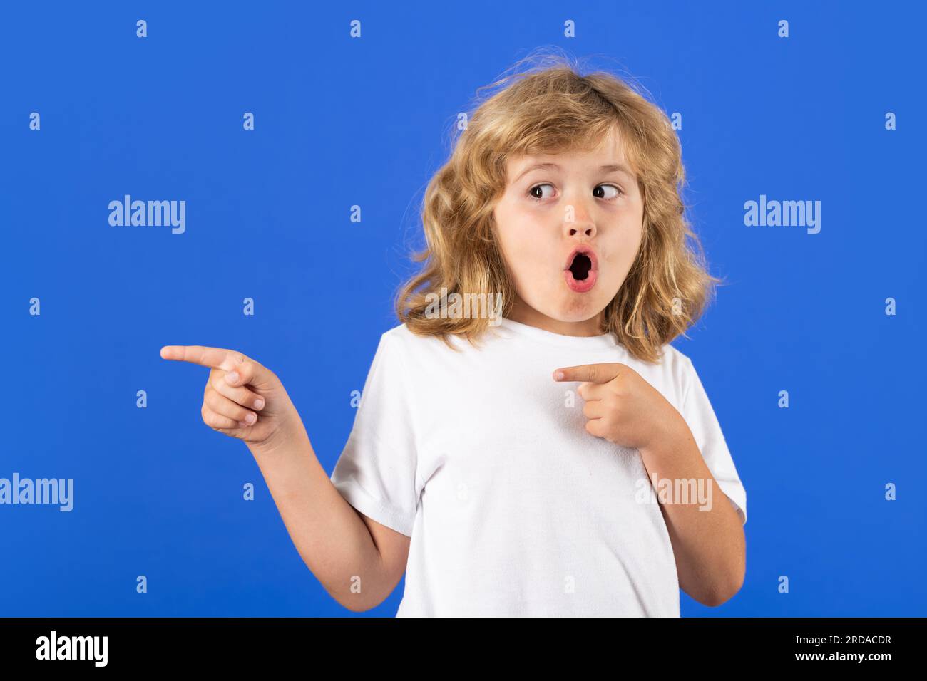Excited kid boy on studio isolated background. Surprised face, amazed ...