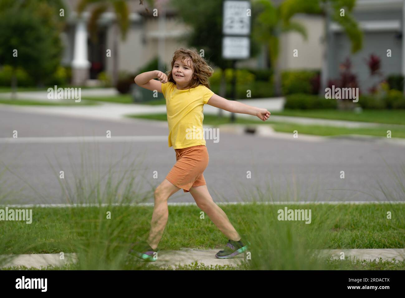 Excited Kid running in street. Amazed child enjoy run. Happy little boy ...