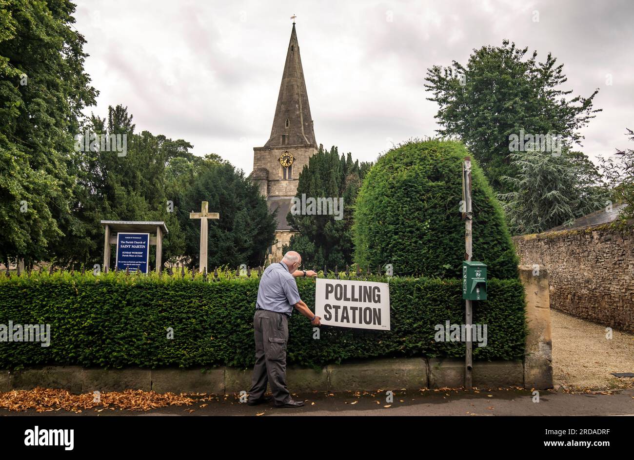 A man adjusts a polling station sign at Saint Martin Church in ...