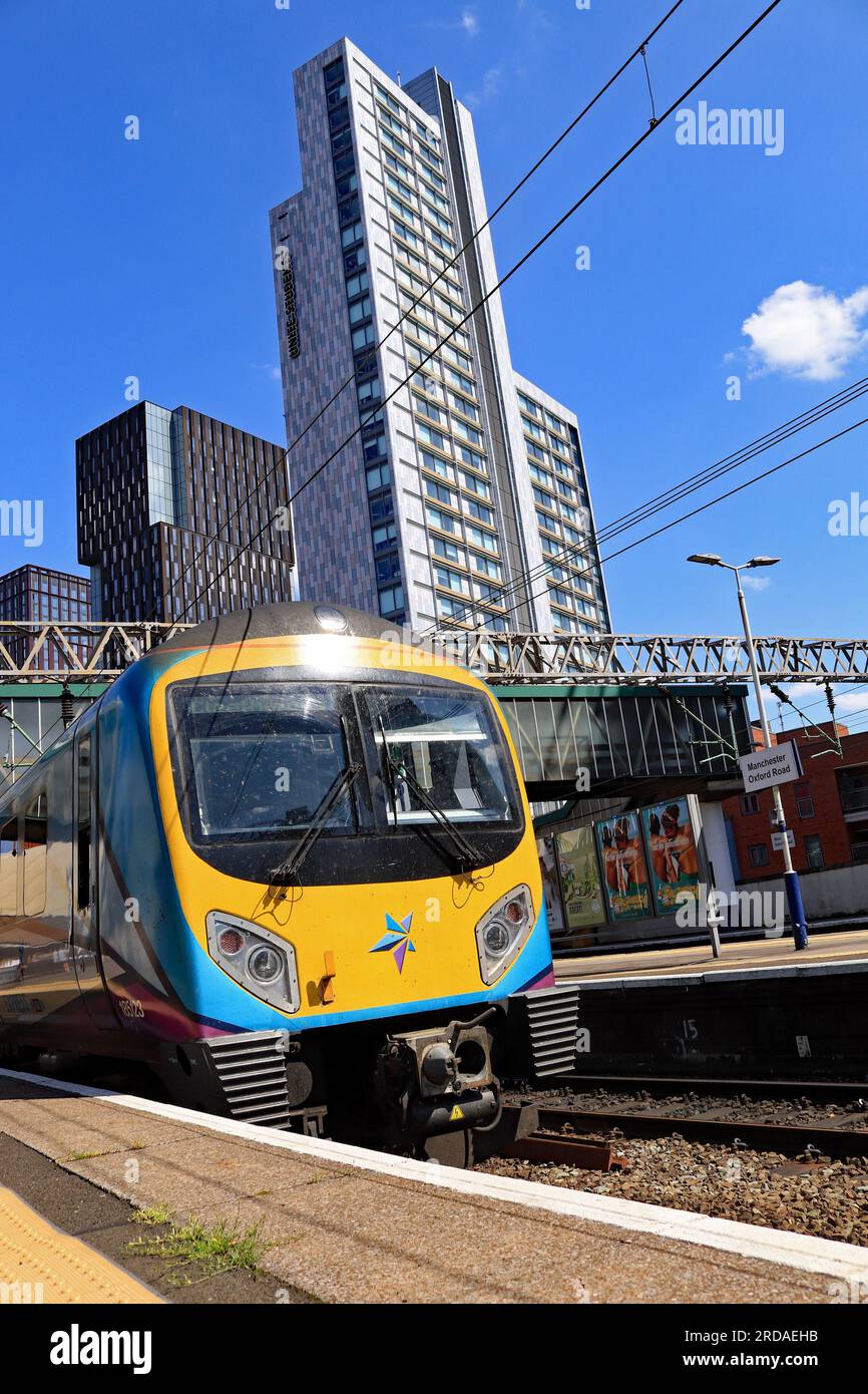 Modern Manchester in the sun. A Trans Pennine Express train below one ...