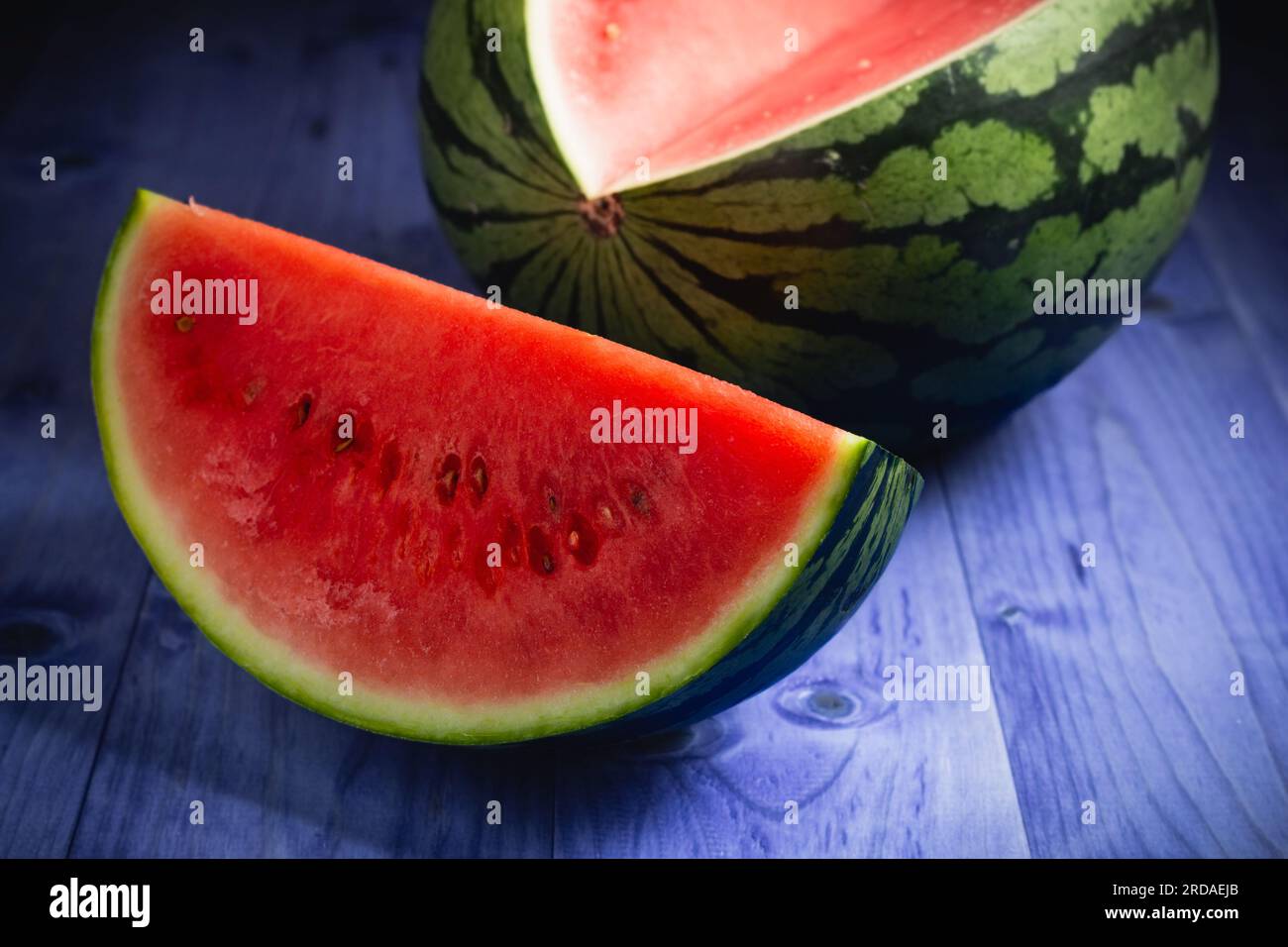 Slices of watermelons on blue background Stock Photo - Alamy