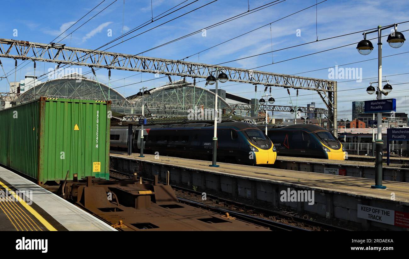 A partly loaded container train passes along platform 13 at Manchester ...