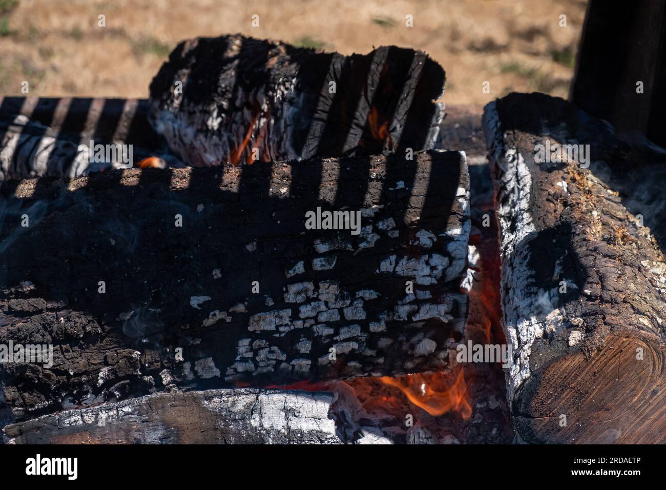 view of embers and firewood for a grill Stock Photo - Alamy