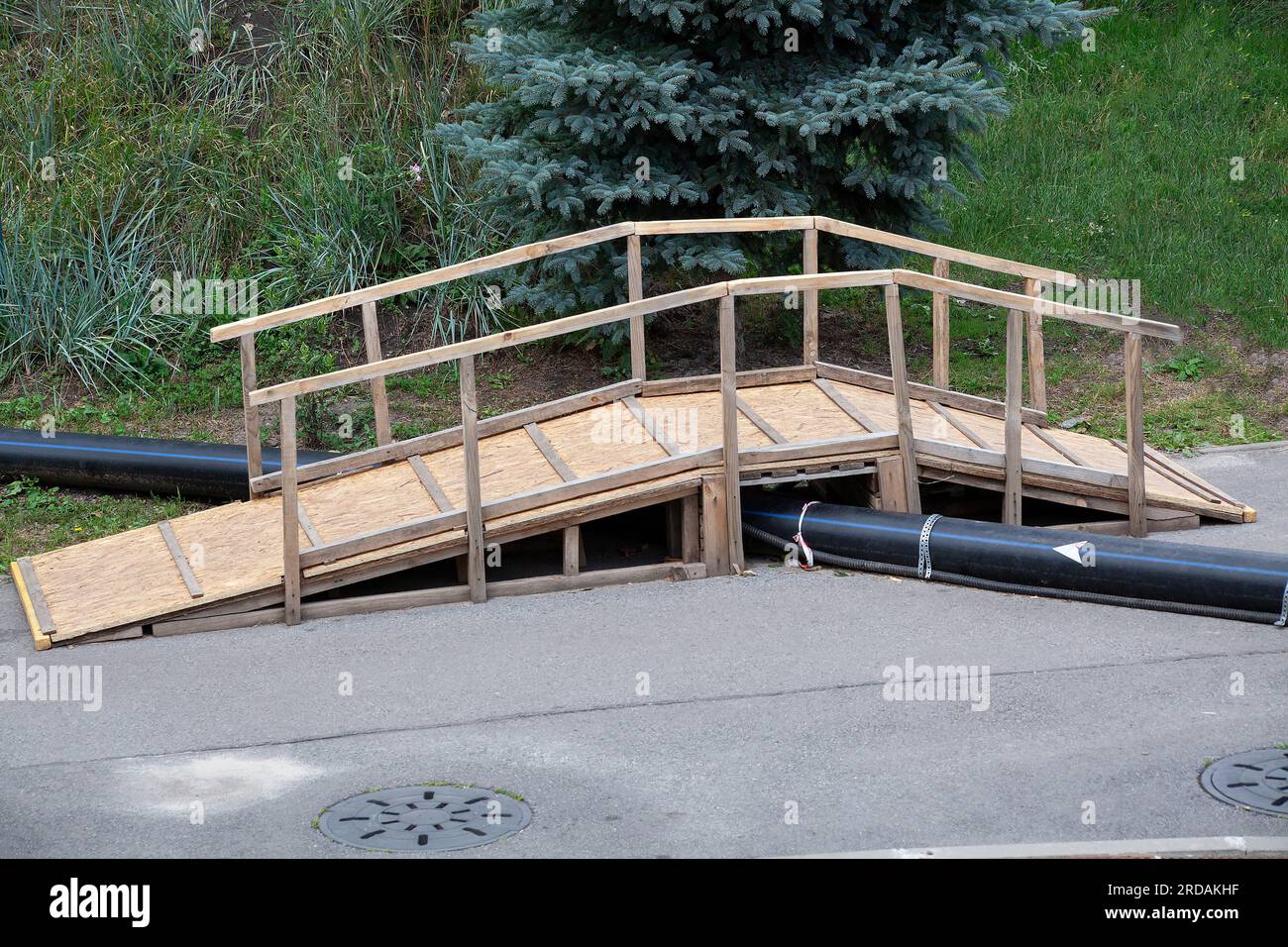 temporary wooden bridge over the pipe on construction site Stock Photo ...