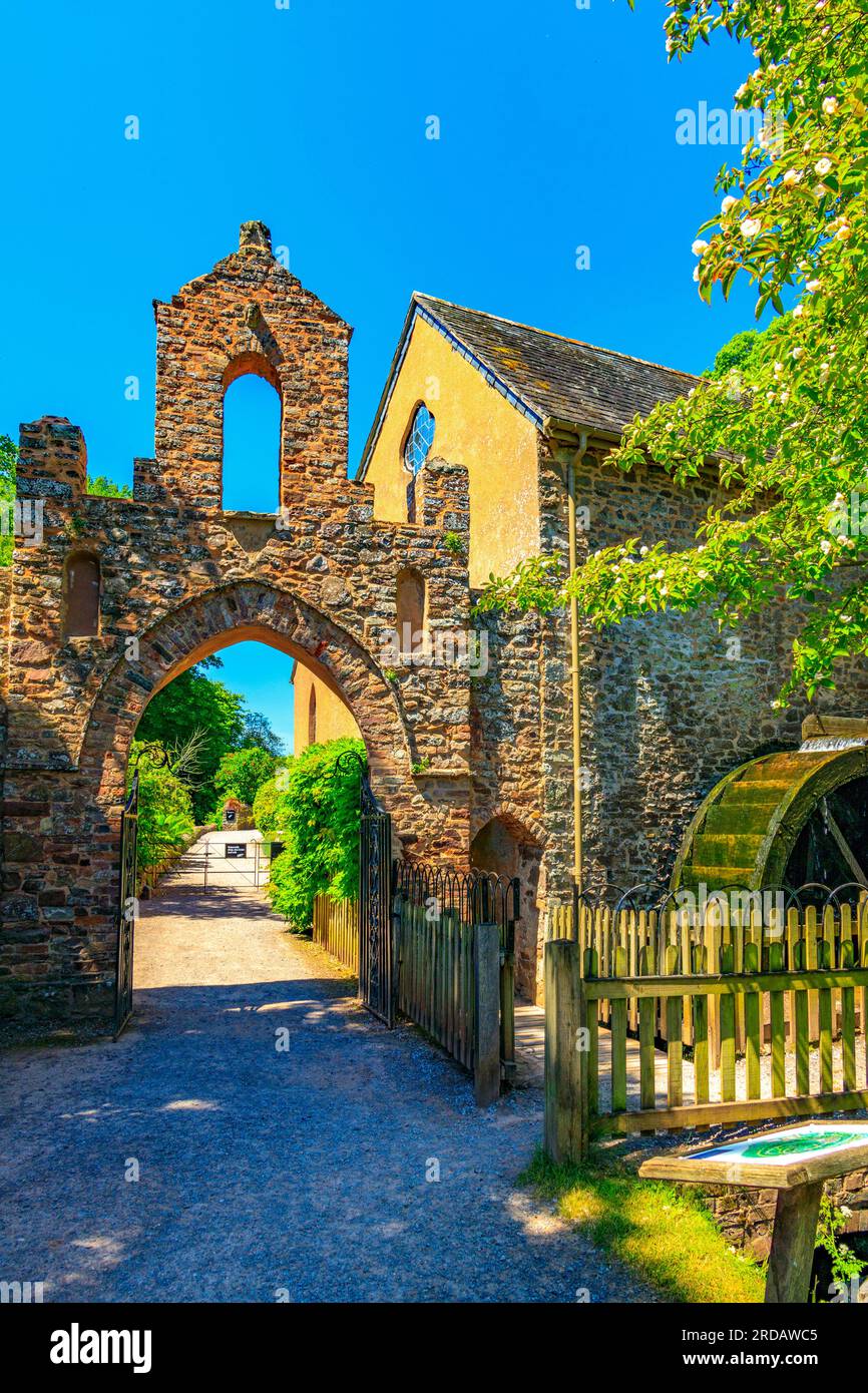The River Avill water mill with a wooden mill wheel at Dunster Castle ...