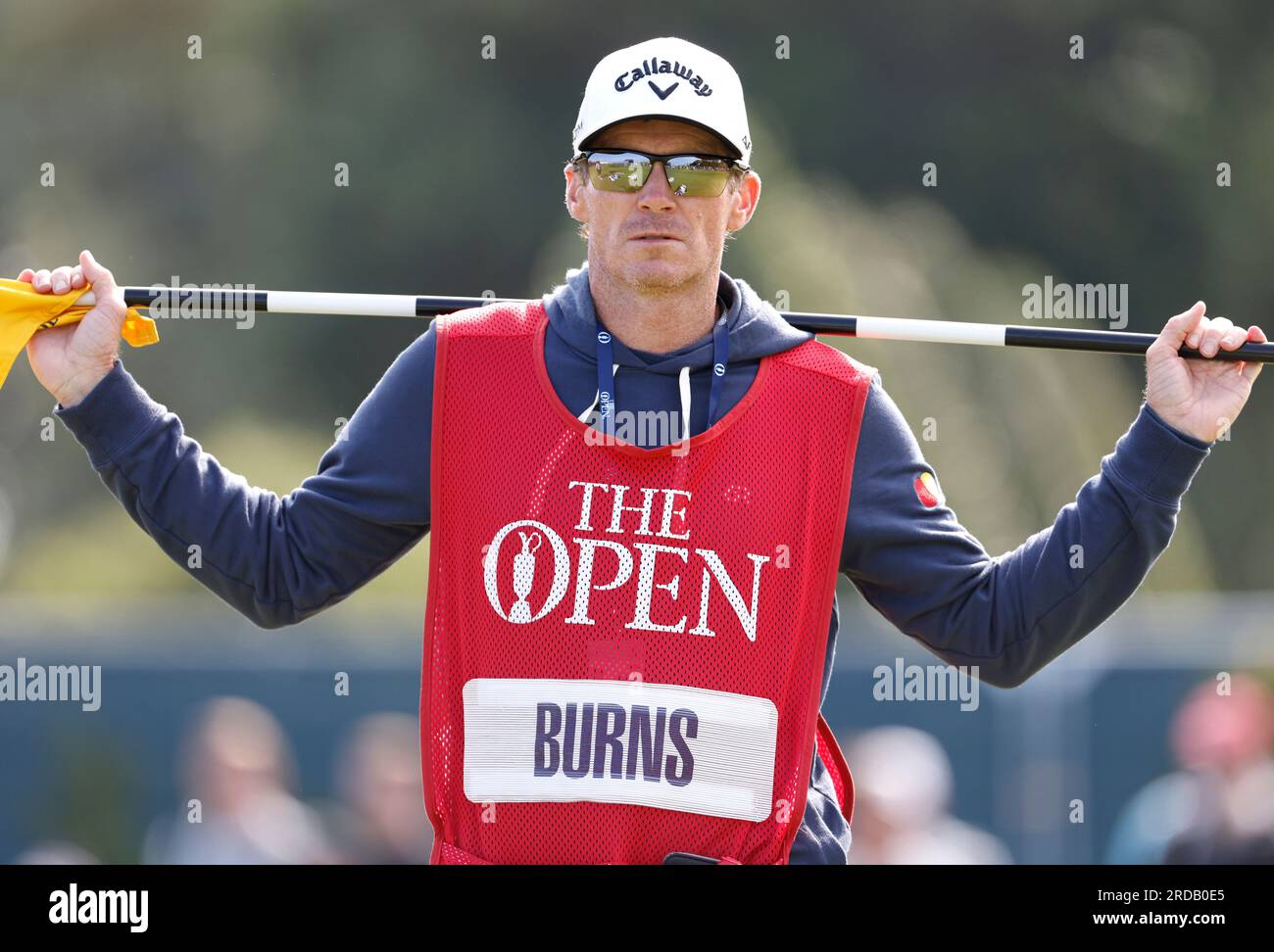 USA's Sam Burns's caddie Travis Perkins with the 4th hole flag during day one of The Open at ...