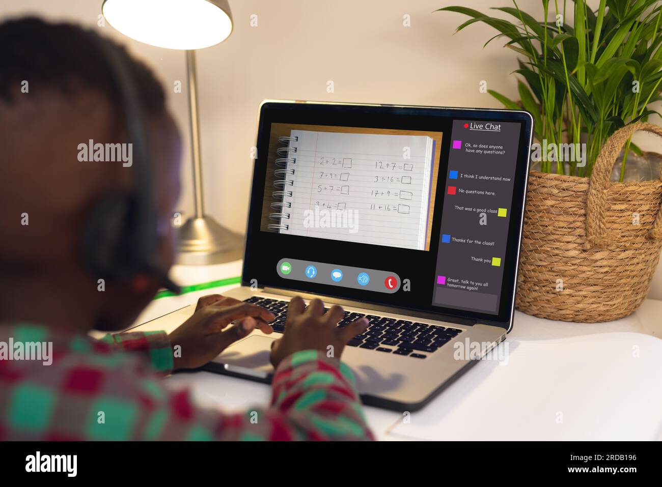 African american boy wearing headphones and learning mathematics over ...