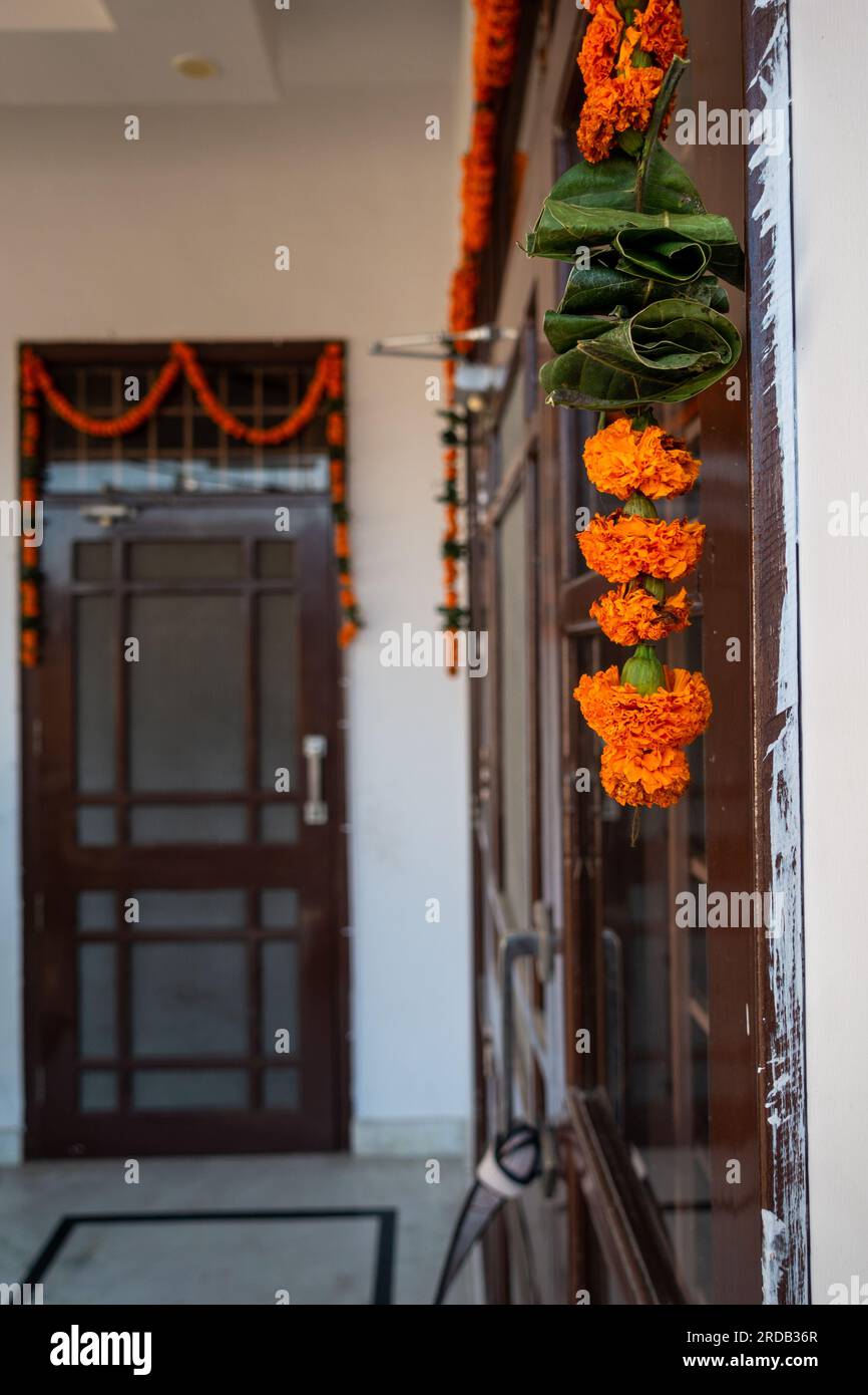 A decorated home with marigold flowers or genda phool garlands during ...