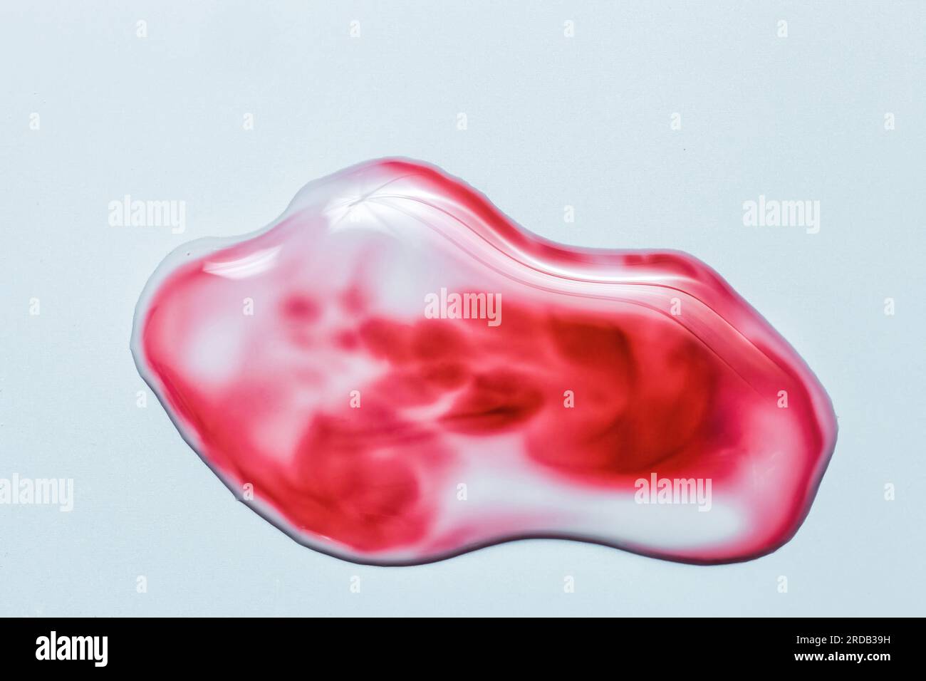 Drop with water and blood on blue background. Colorful glossy droplet ...