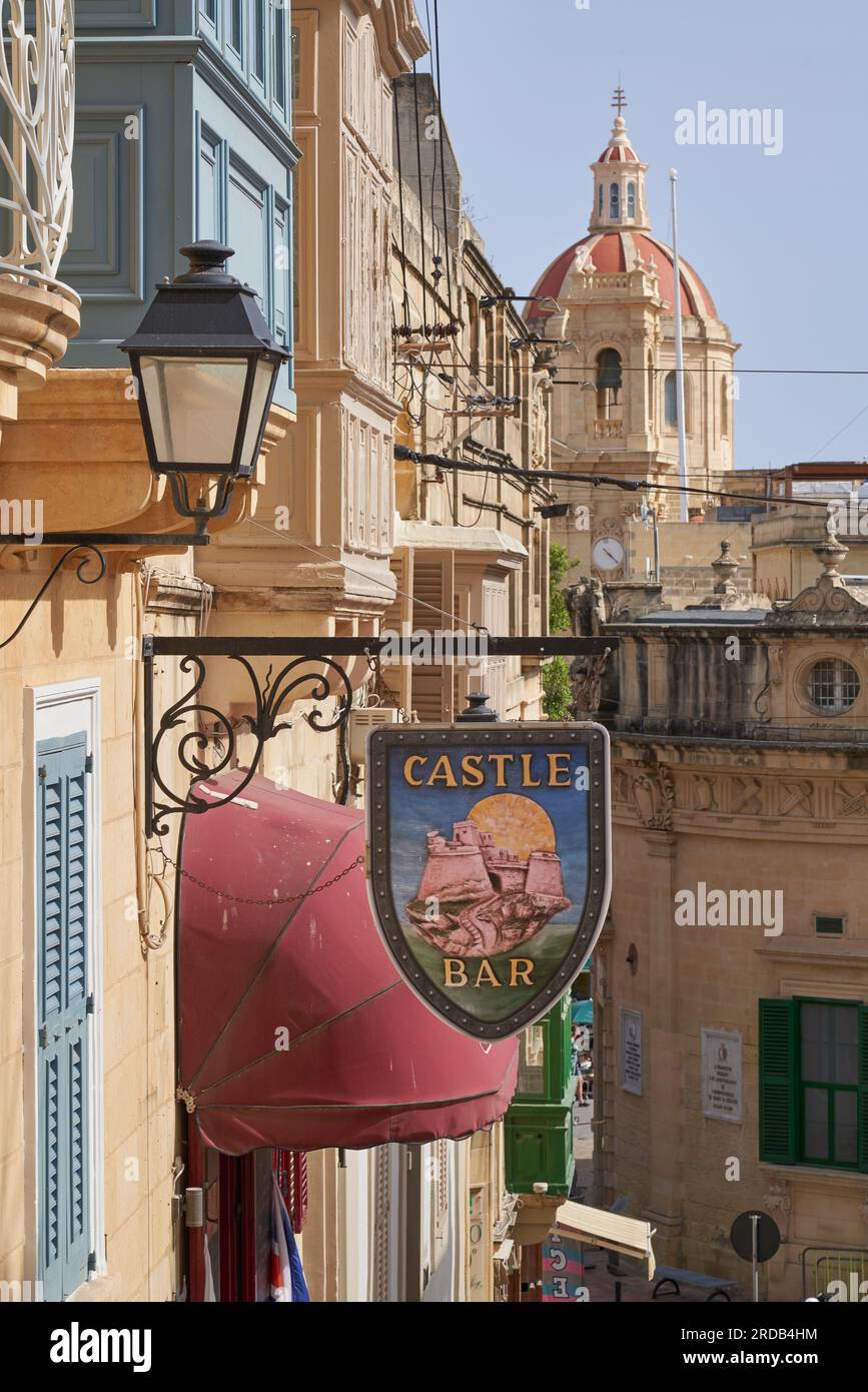 Historic buildings in Victoria on the island of Gozo in Malta. Sign for ...