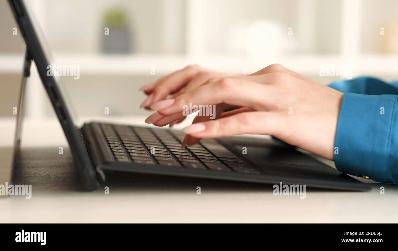 Working online laptop typing woman hands desk Stock Photo - Alamy