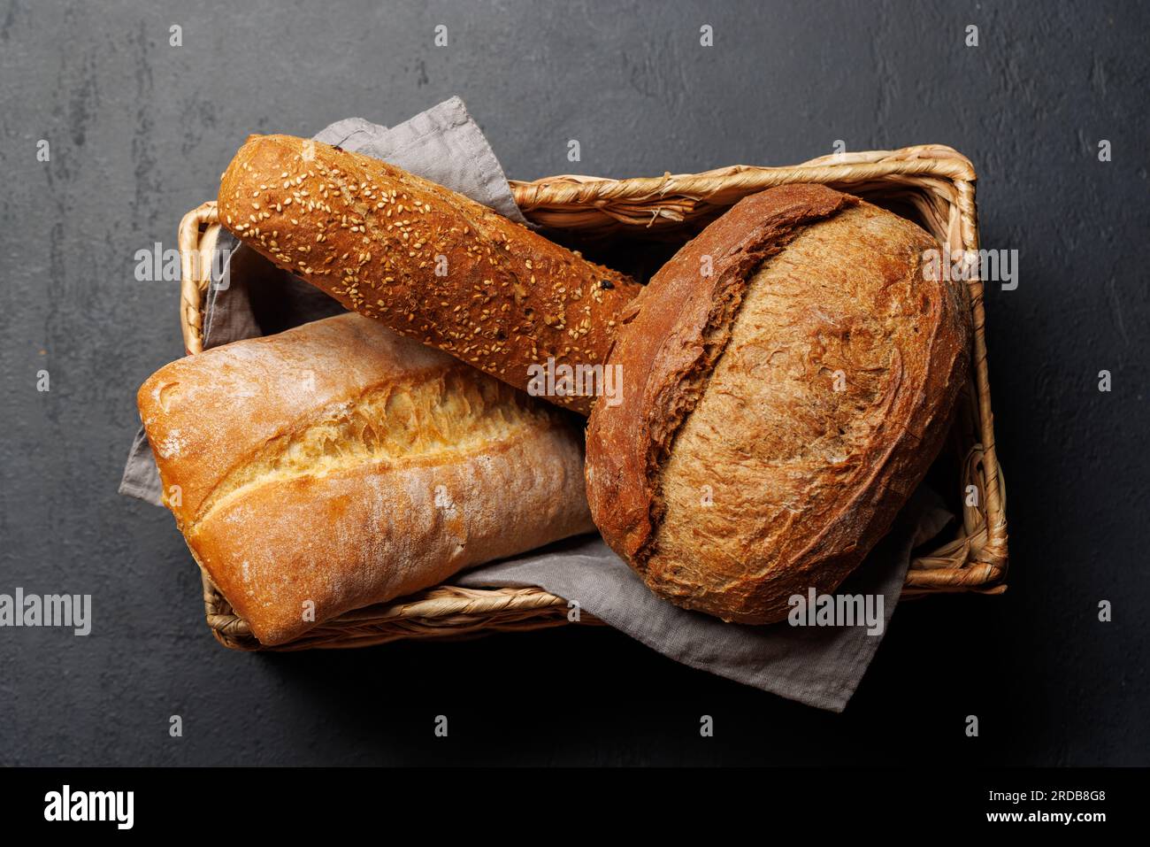 Assorted bread varieties in a charming basket, ready to be enjoyed ...
