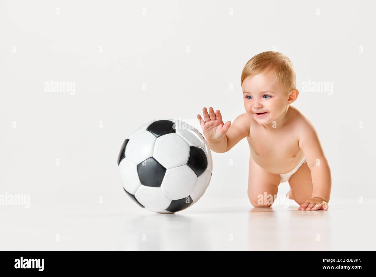Happy, smiling little baby, toddler in diaper crawling and playing with ...