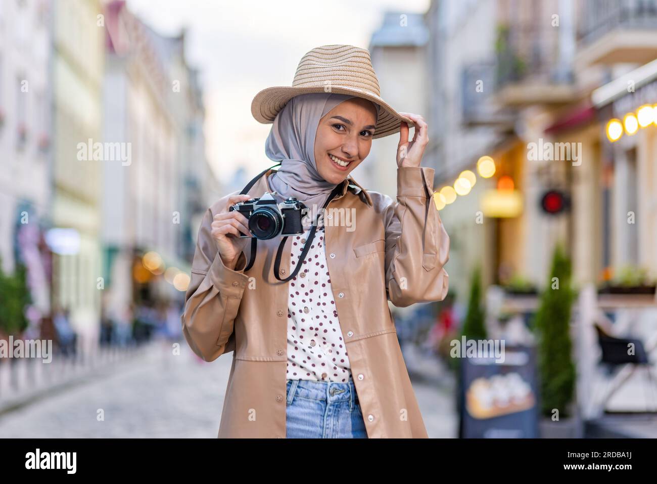 Portrait of young beautiful Muslim woman in hijab and hat, tourist ...