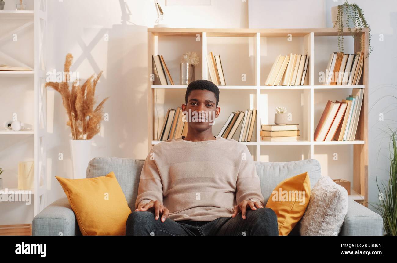 Happy renter interior enjoyment man sofa home Stock Photo - Alamy