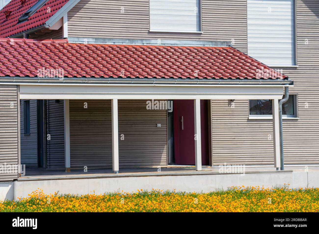 Beautiful wooden carport in front of a residential house with wood-clad ...