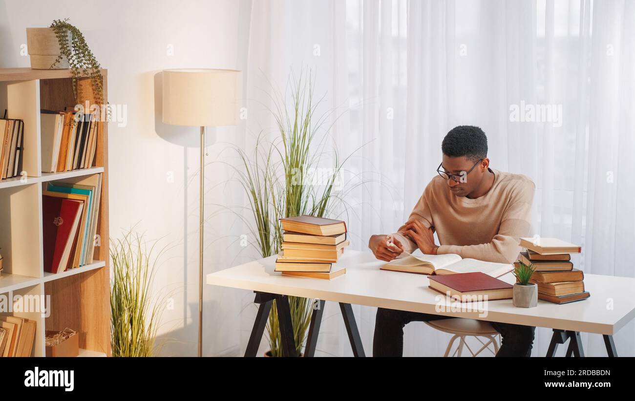 Education concentration study hard man book home Stock Photo - Alamy