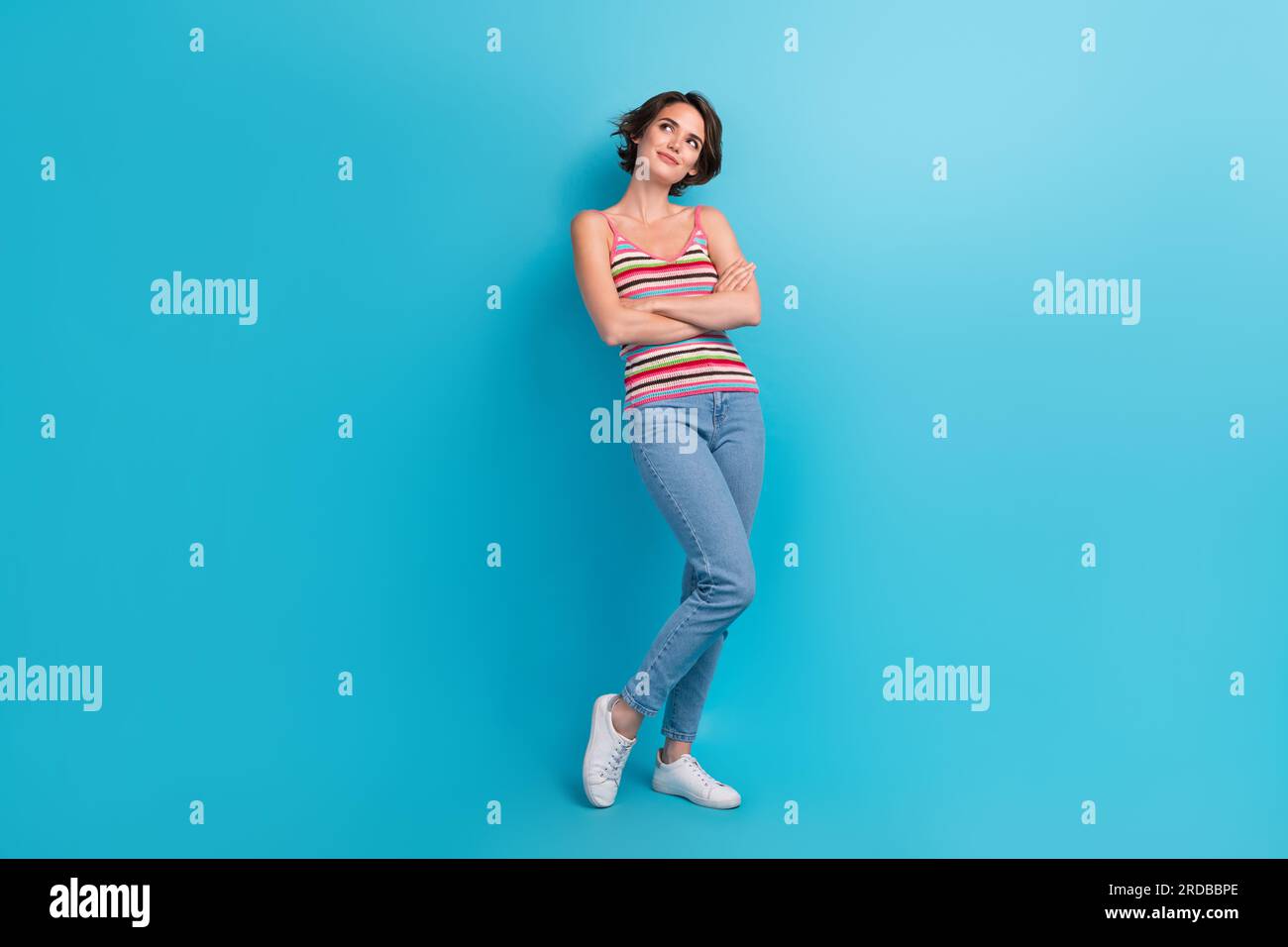 Full body photo of minded creative pretty girl folded arms look empty ...