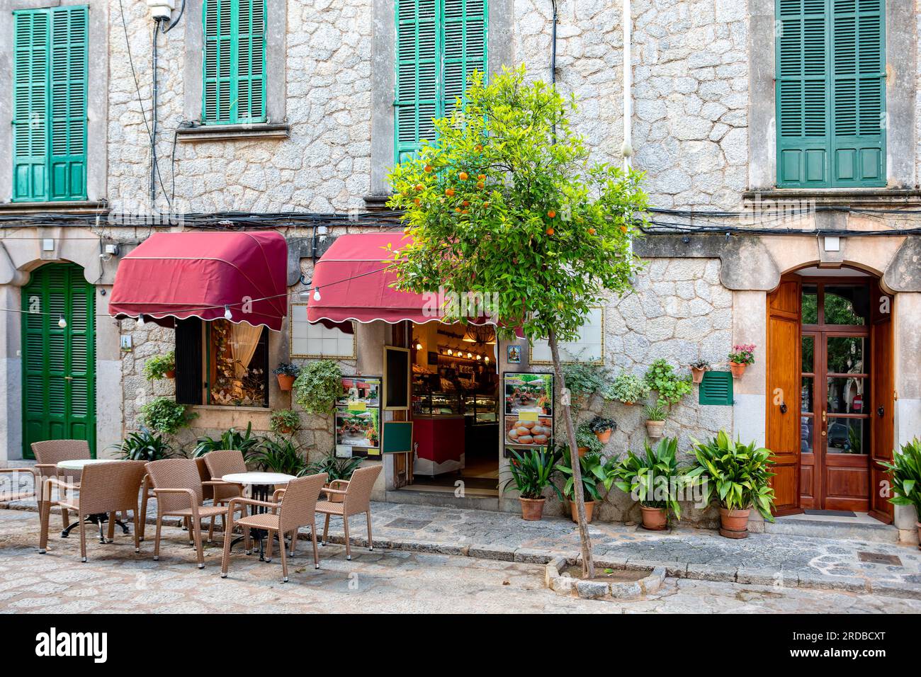 A cafe in a narrow street in the historic center of Valldemossa ...