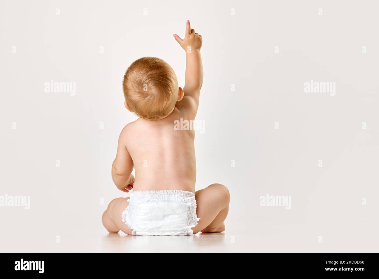 Back view image of little baby, child, toddler sitting in diaper ...
