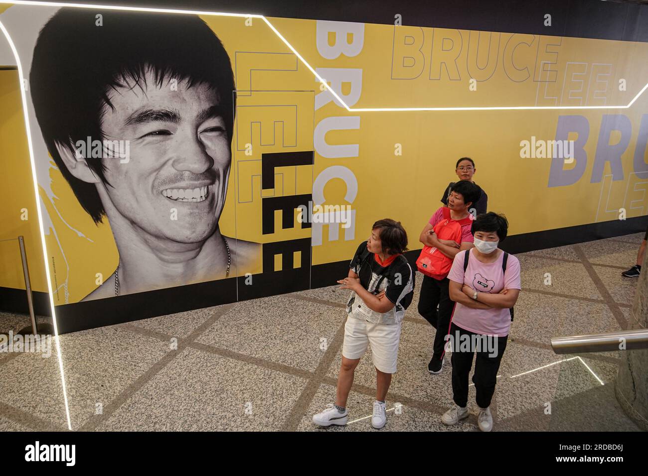 People walk past a poster of Bruce Lee. The Hong Kong government ...
